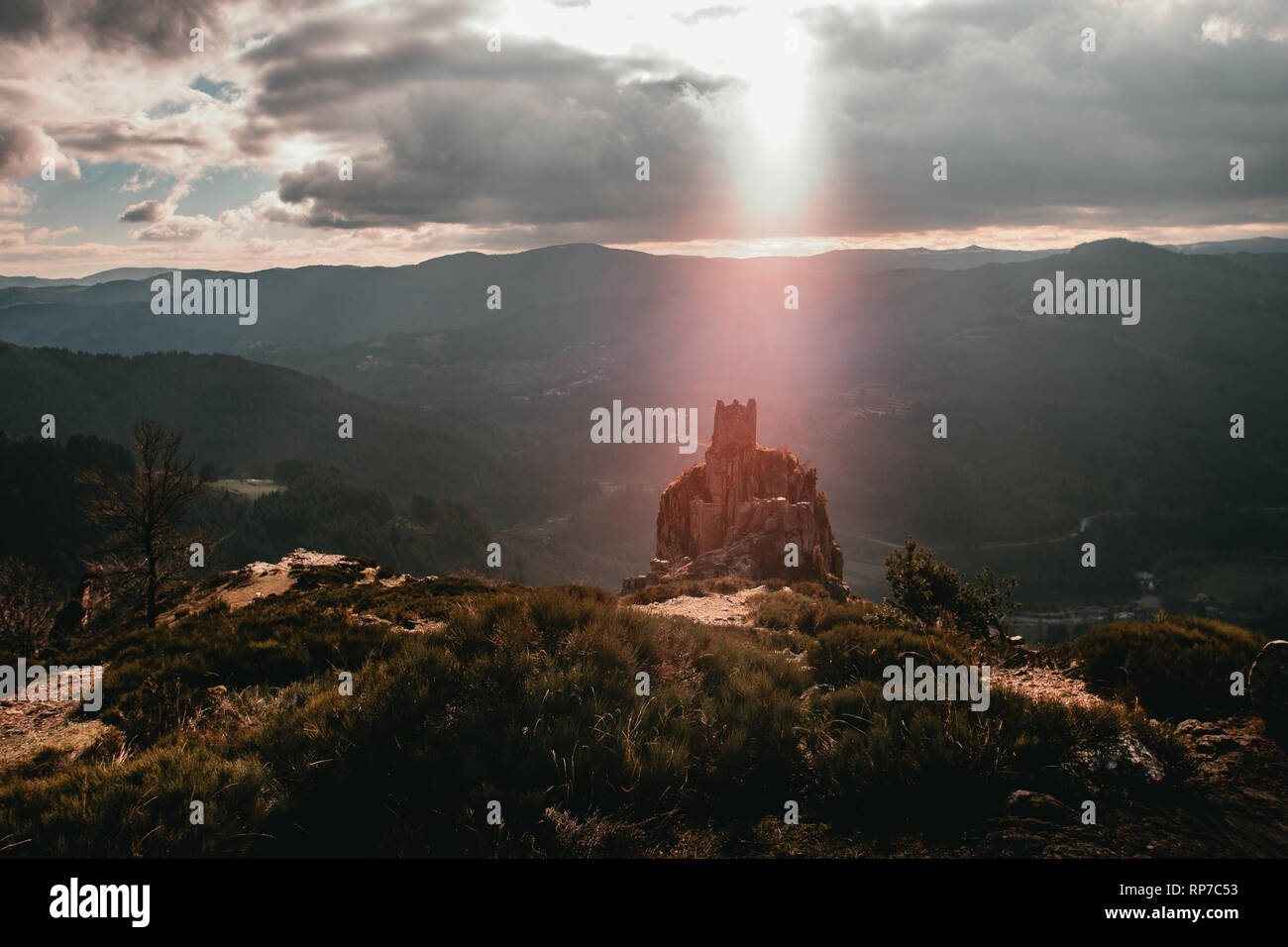 Lightbeam shining on medieval tower ruins built on a rock. (Vestiges du ...