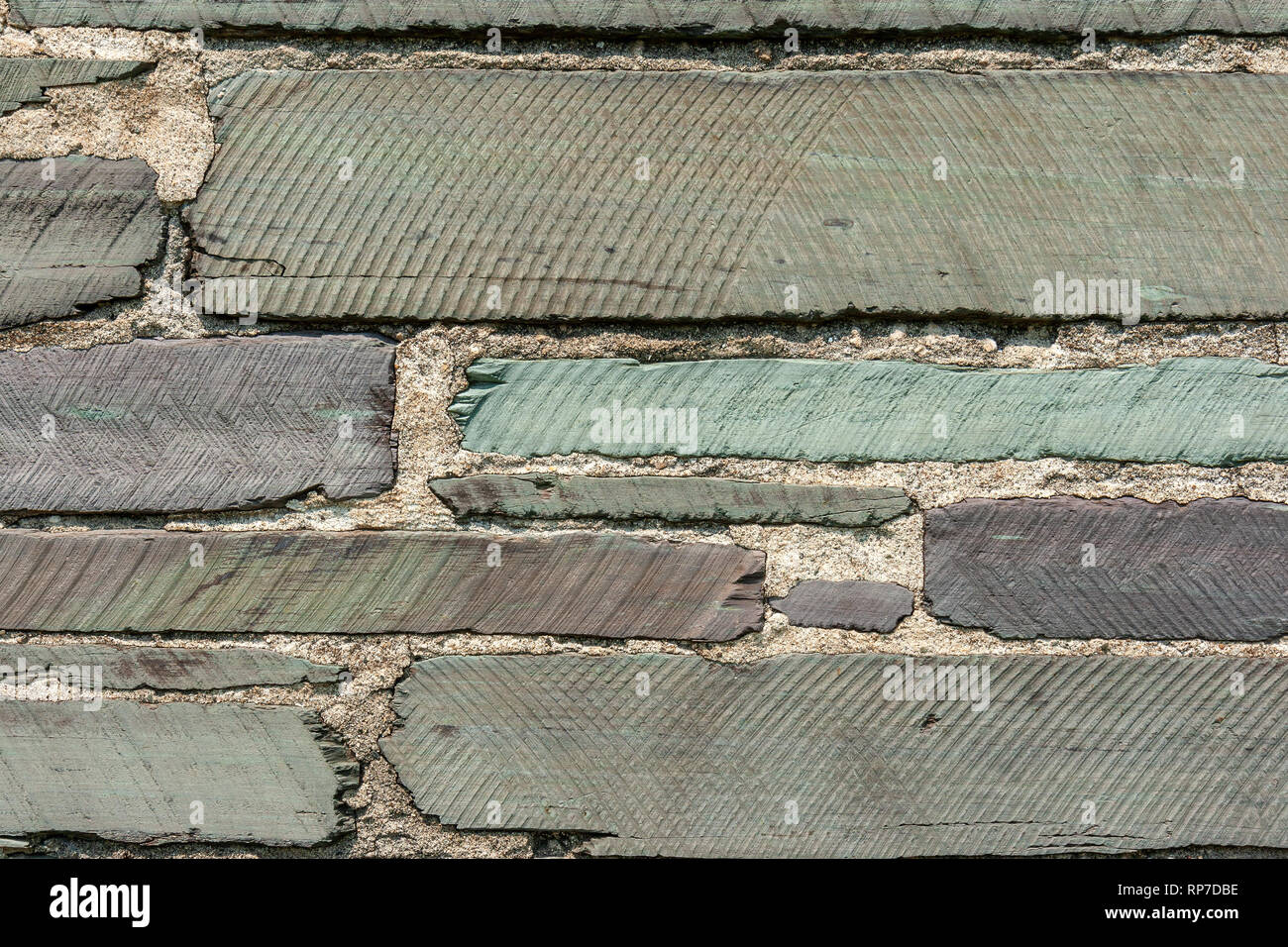 Detail of a colorful slate stone wall Stock Photo - Alamy