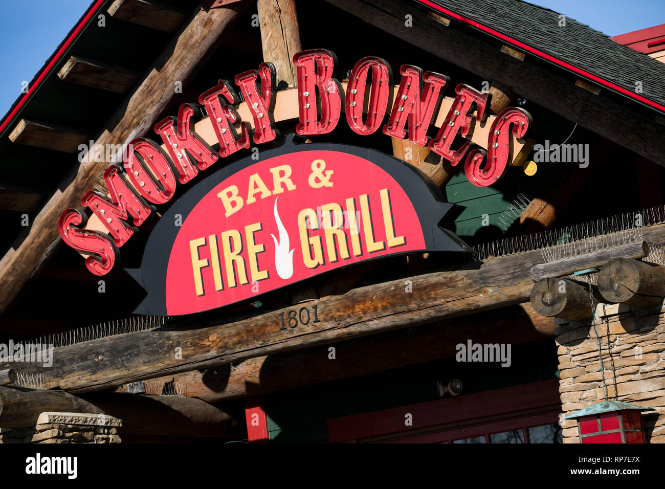 A logo sign outside of a Smokey Bones Bar and Fire Grill restaurant ...