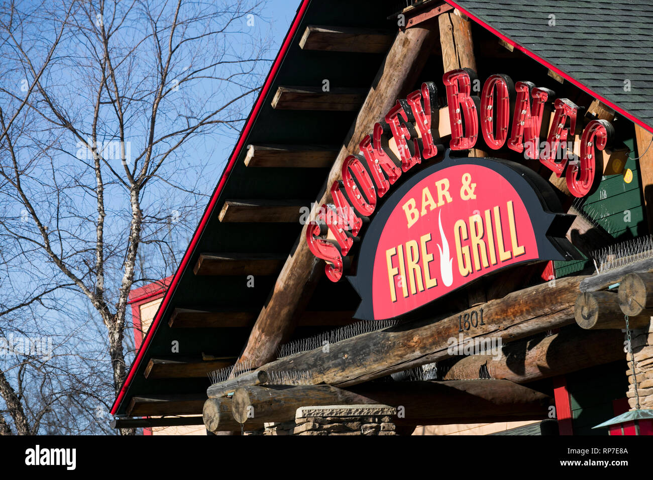 A logo sign outside of a Smokey Bones Bar and Fire Grill restaurant ...