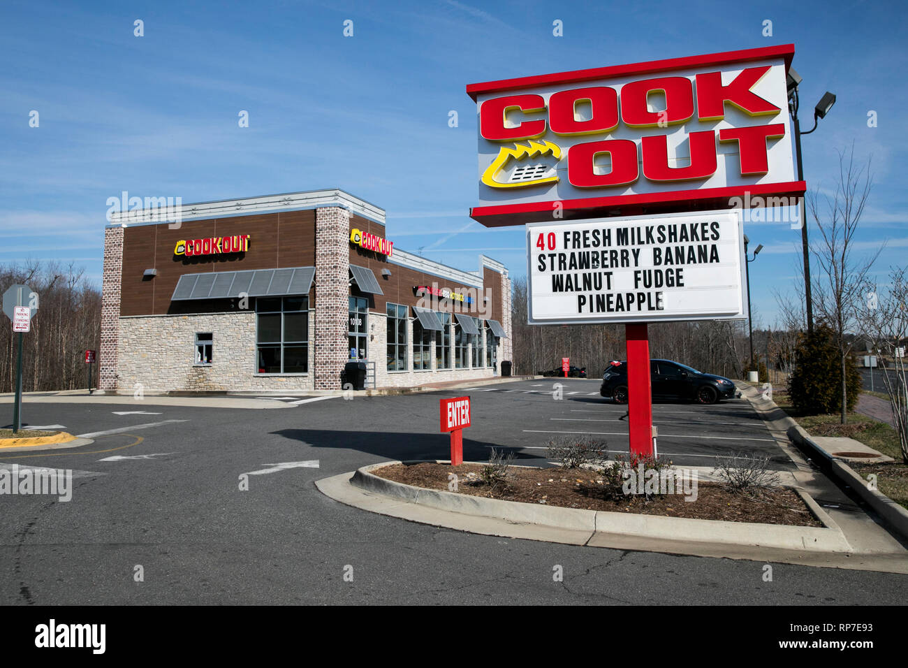 A logo sign outside of a Cook Out fast food restaurant location in ...