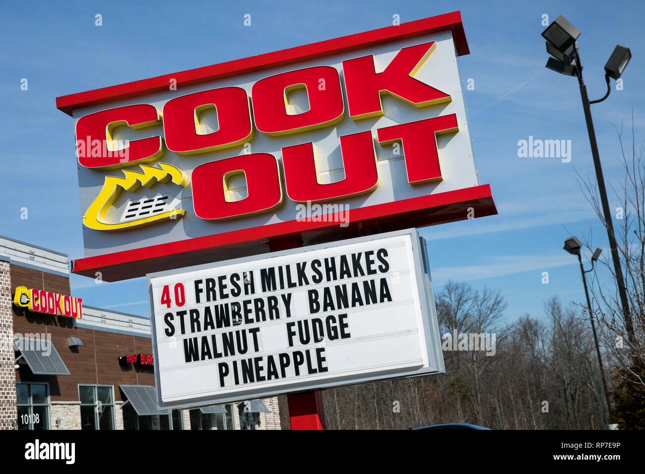 A logo sign outside of a Cook Out fast food restaurant location in ...
