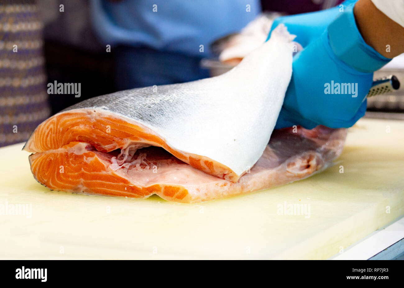 chef slicing raw fresh salmon, Chef preparing a fresh salmon on a ...