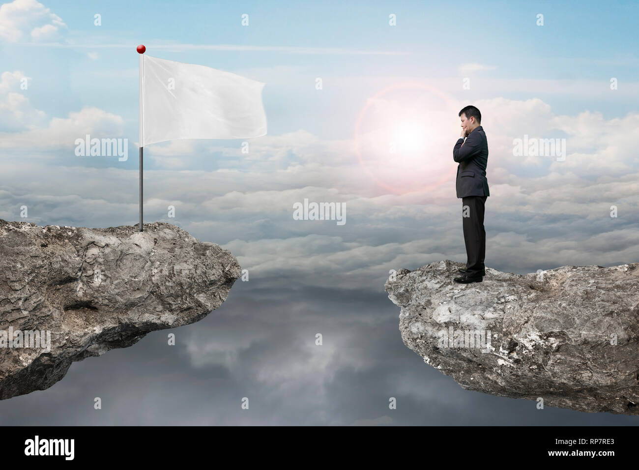 Manager standing on cliff with blank white flag and natural sunlight ...