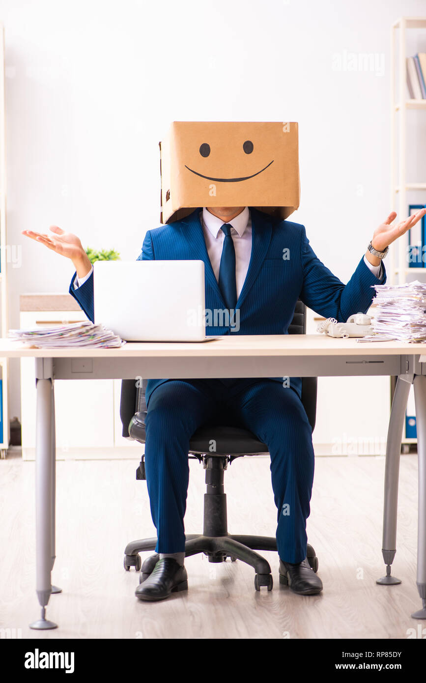 Happy man employee with box instead of his head Stock Photo - Alamy