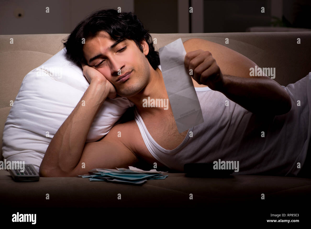 Young man calculating expences hi-res stock photography and images - Alamy