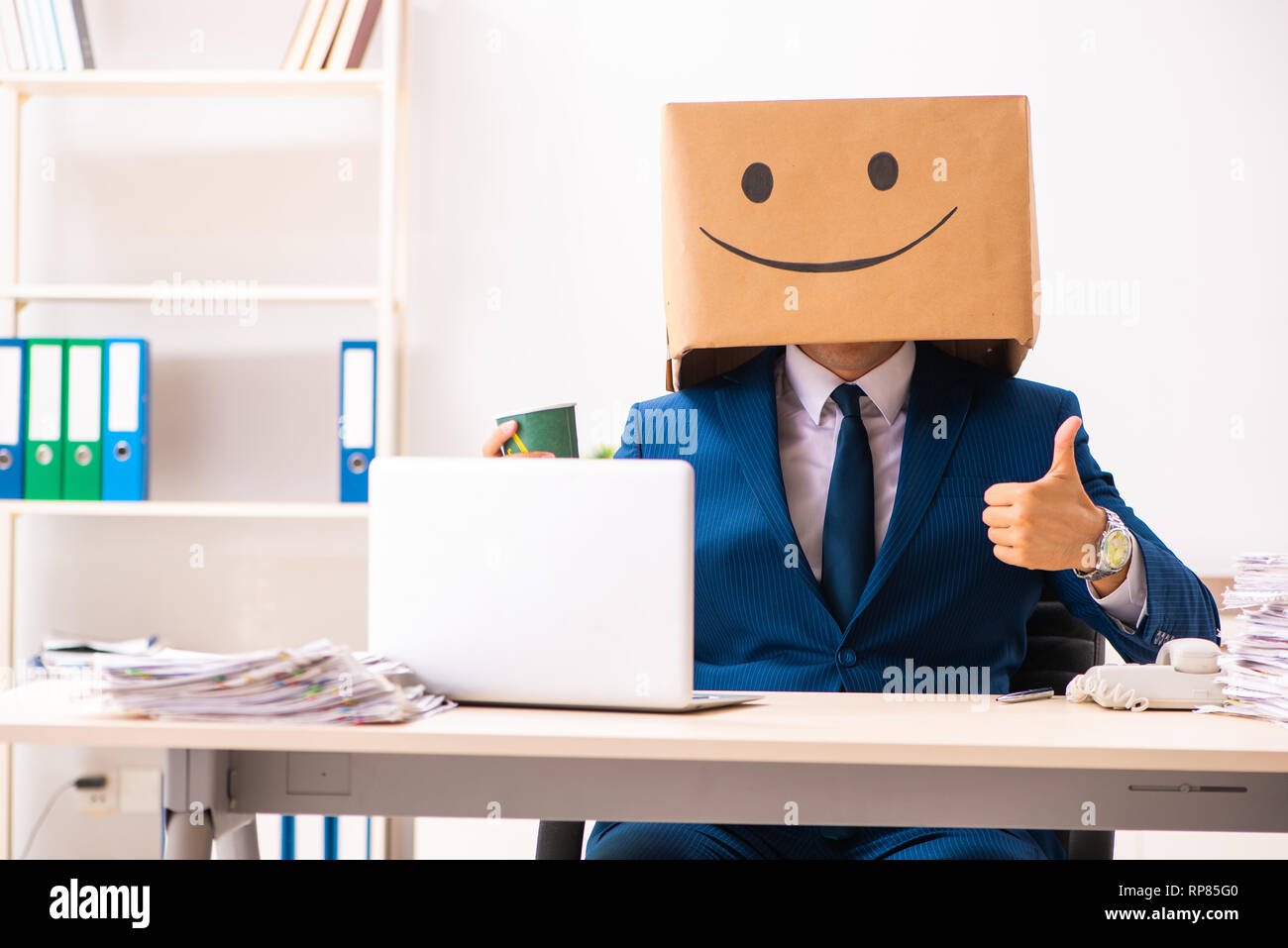 Happy man employee with box instead of his head Stock Photo - Alamy