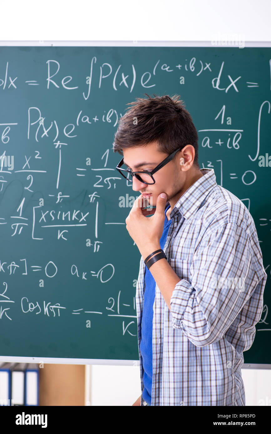 Young male student studying math at school Stock Photo - Alamy