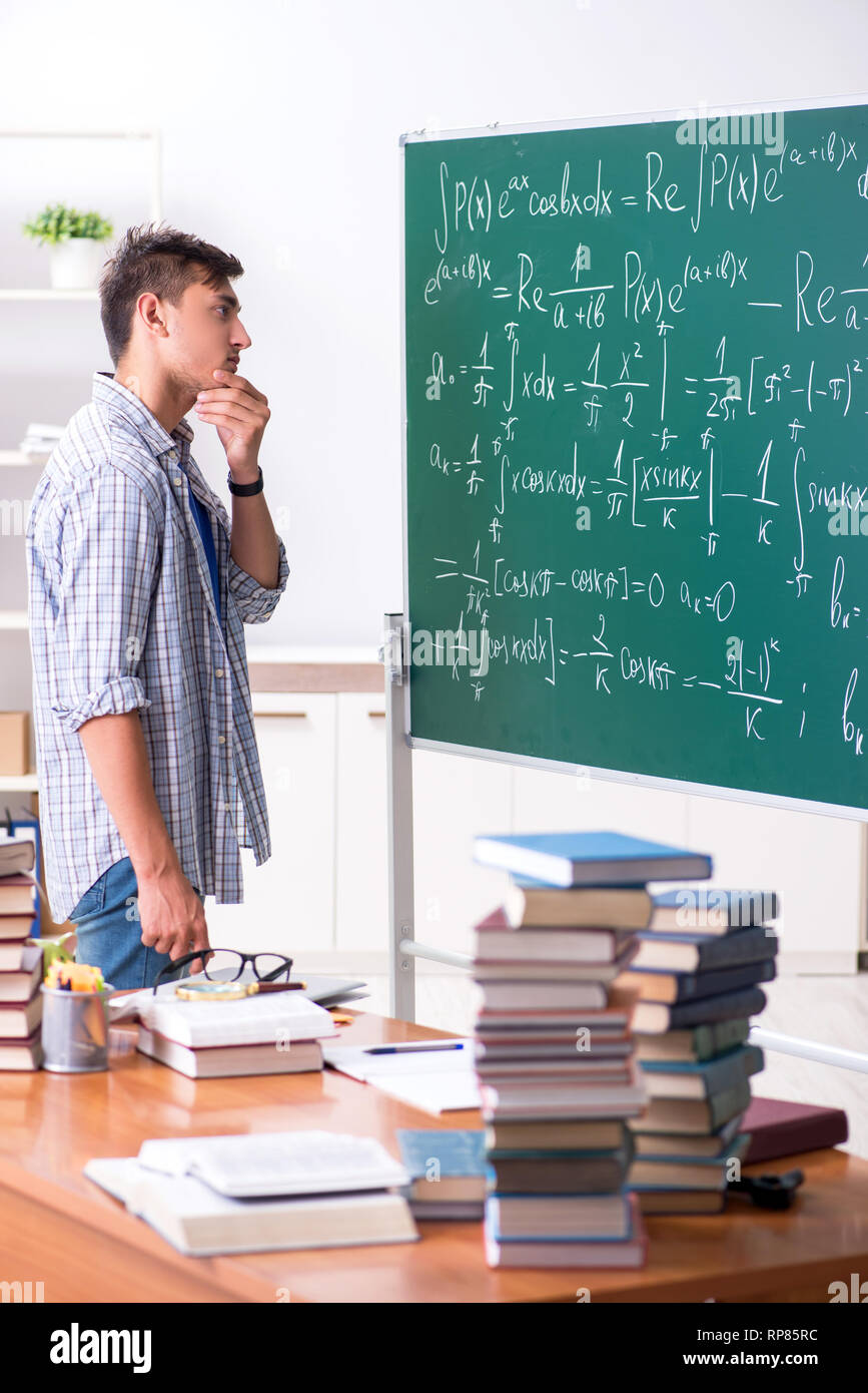 Young male student studying math at school Stock Photo - Alamy