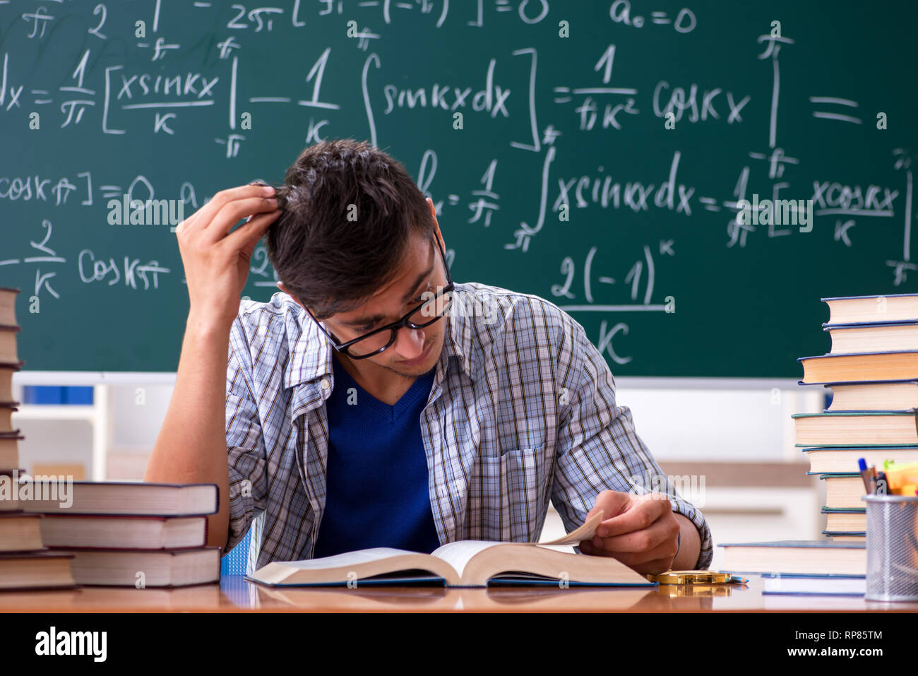 Young male student studying math at school Stock Photo - Alamy