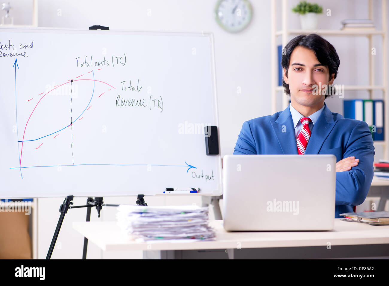 Busy businessman explaining business charts Stock Photo - Alamy