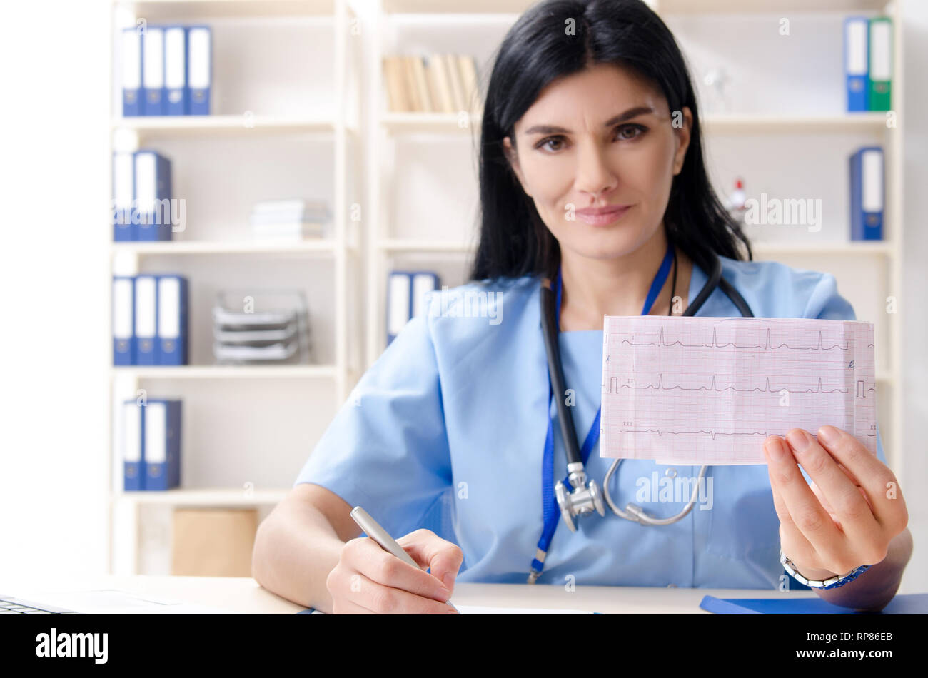 Female doctor cardiologist working in the clinic Stock Photo - Alamy