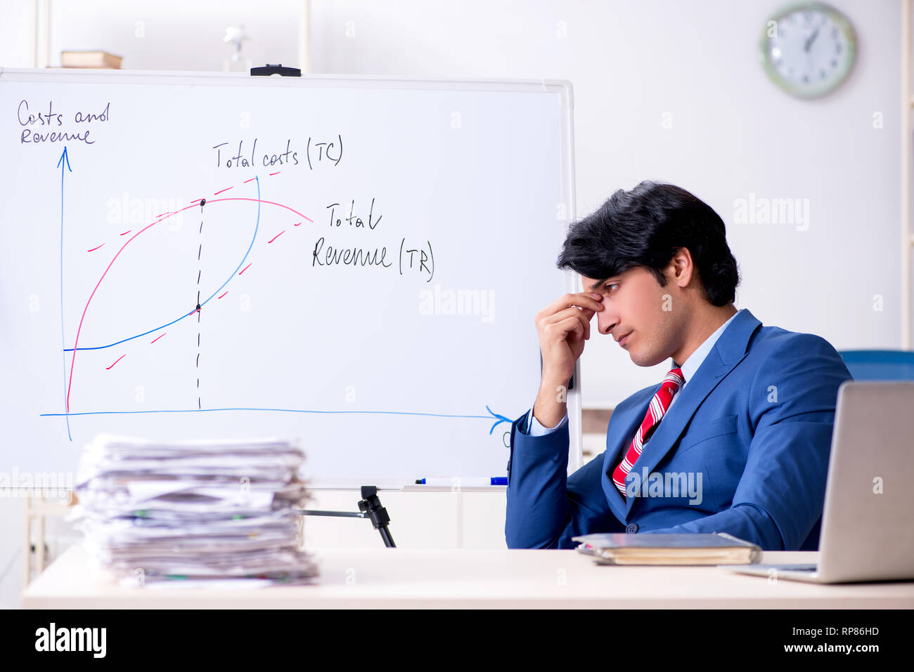Busy businessman explaining business charts Stock Photo - Alamy
