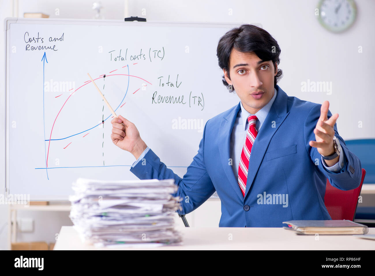 Busy businessman explaining business charts Stock Photo - Alamy