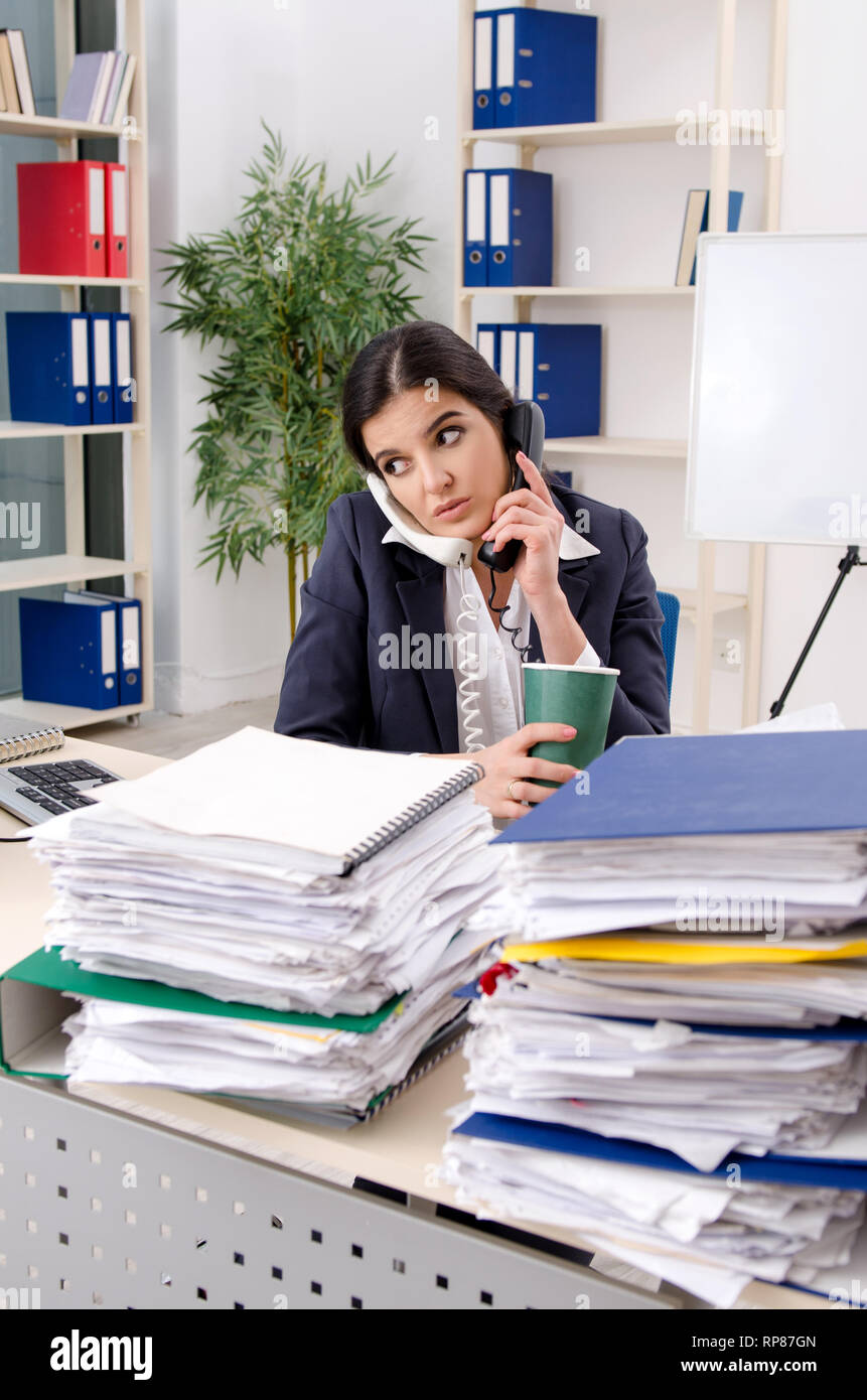 Female employee with too much work in the office Stock Photo - Alamy