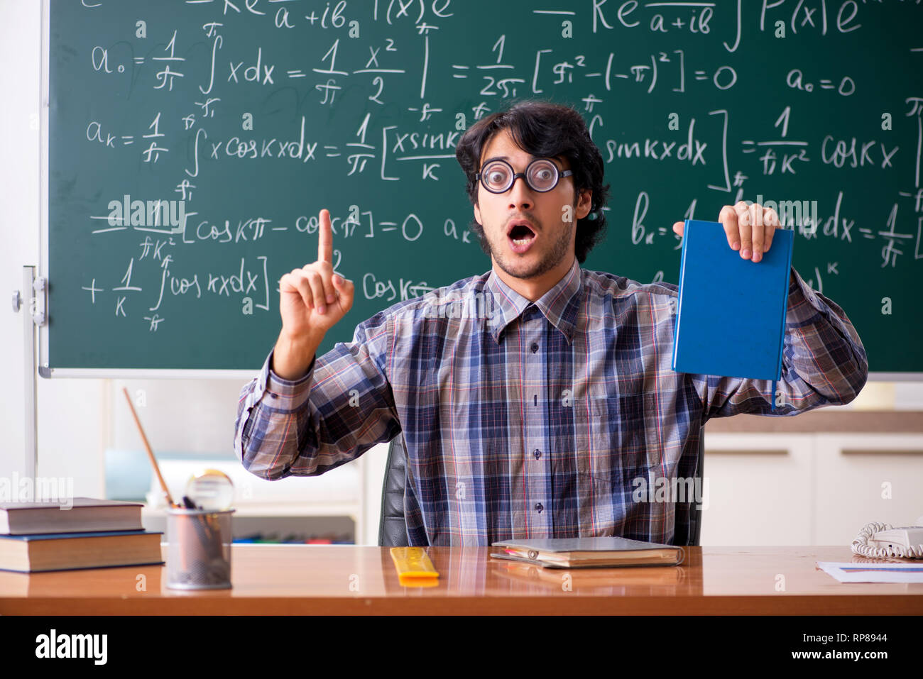 Funny male math teacher in the classroom Stock Photo - Alamy