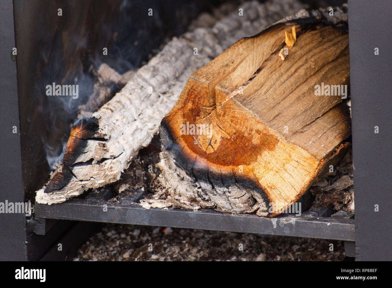 Burning firewood and carbon in fireplace or smokehouse Stock Photo - Alamy