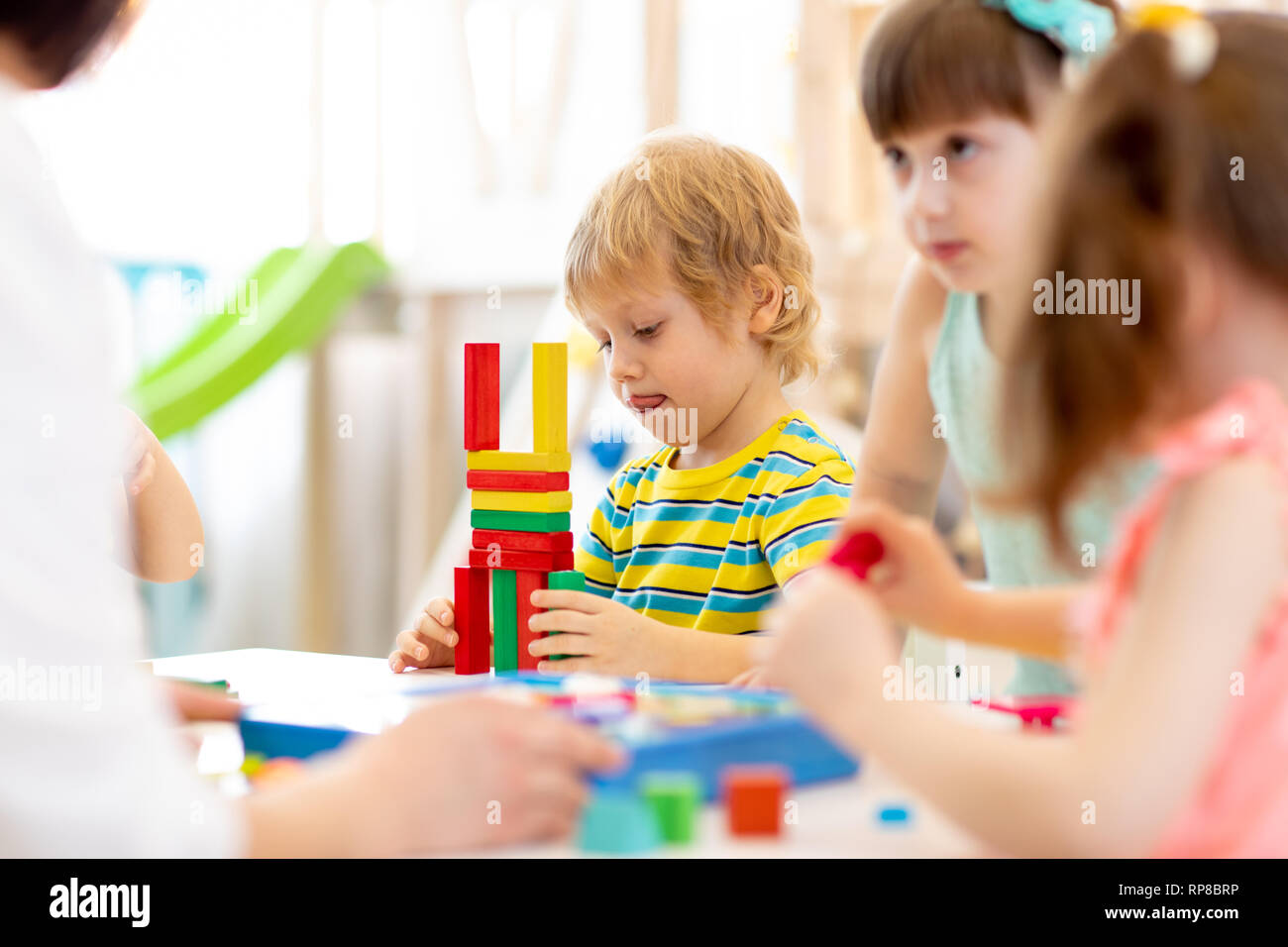 Kids playing with color block toys in kindergarten Stock Photo - Alamy