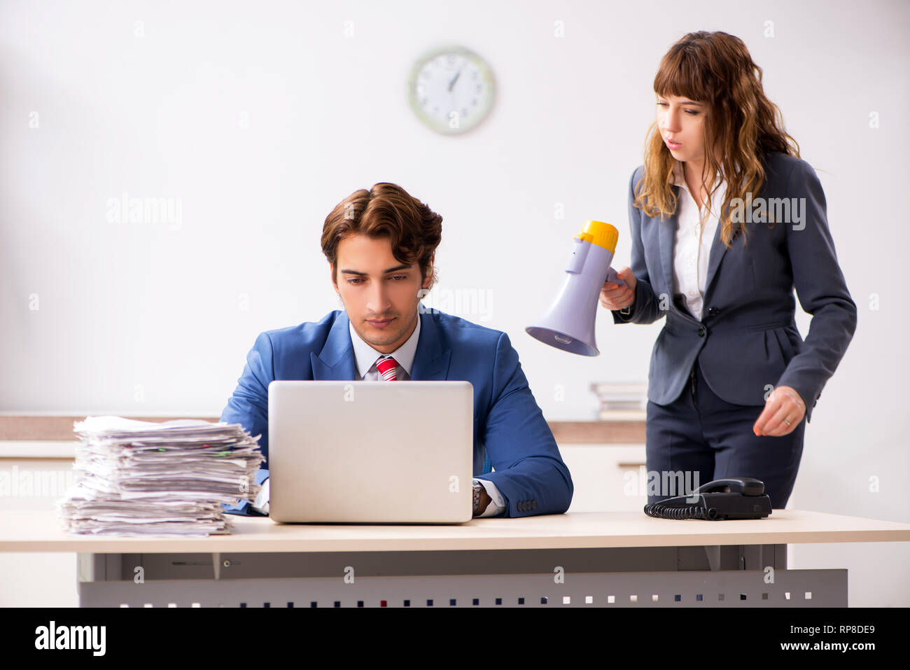 Deaf employee using hearing aid talking to boss Stock Photo - Alamy