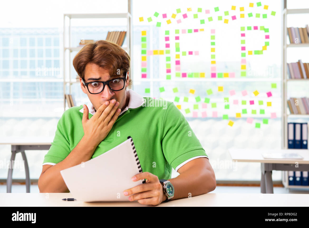 Student struggling at the exam in classroom Stock Photo - Alamy