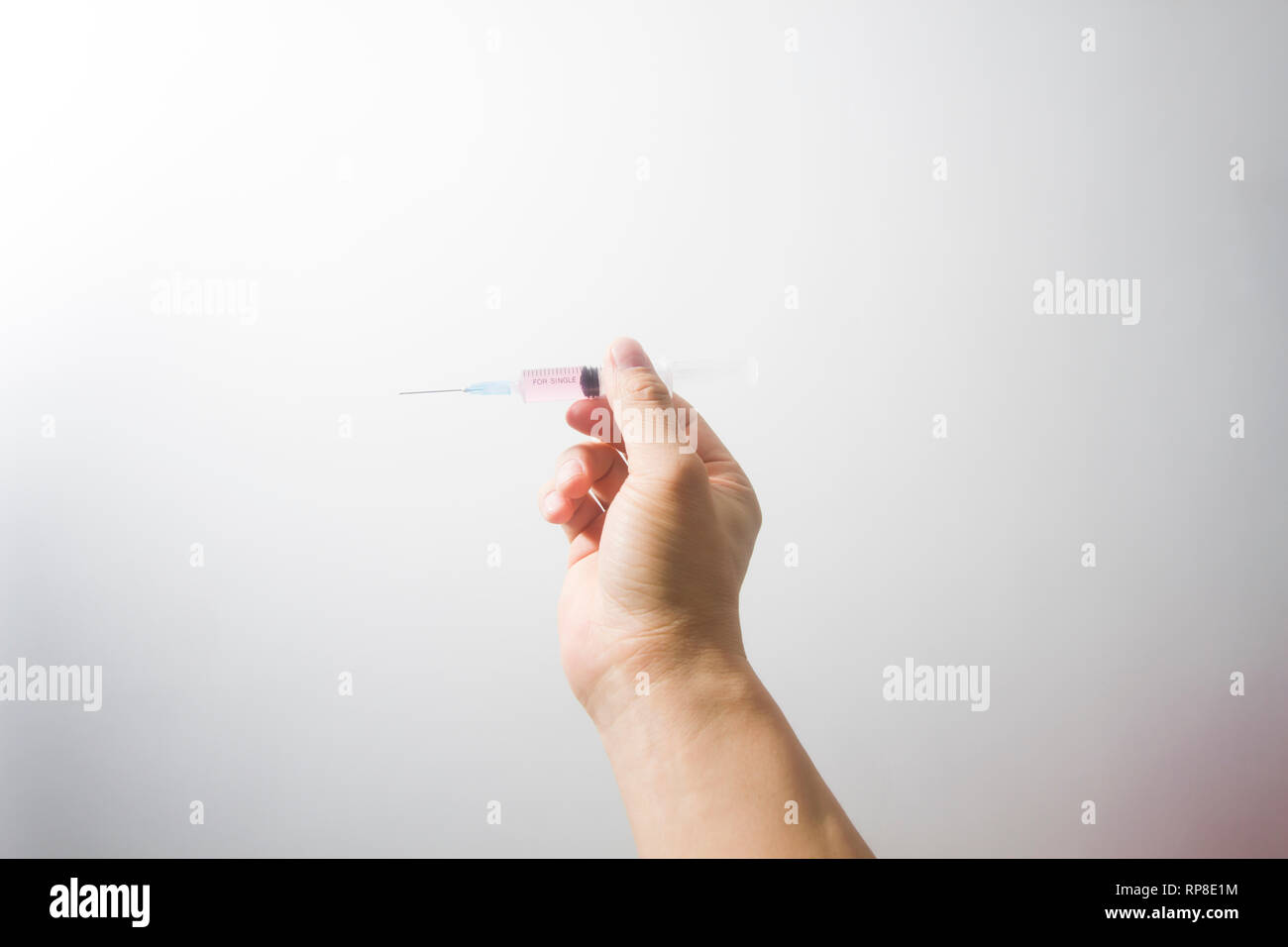 Syringe and arm Stock Photo - Alamy