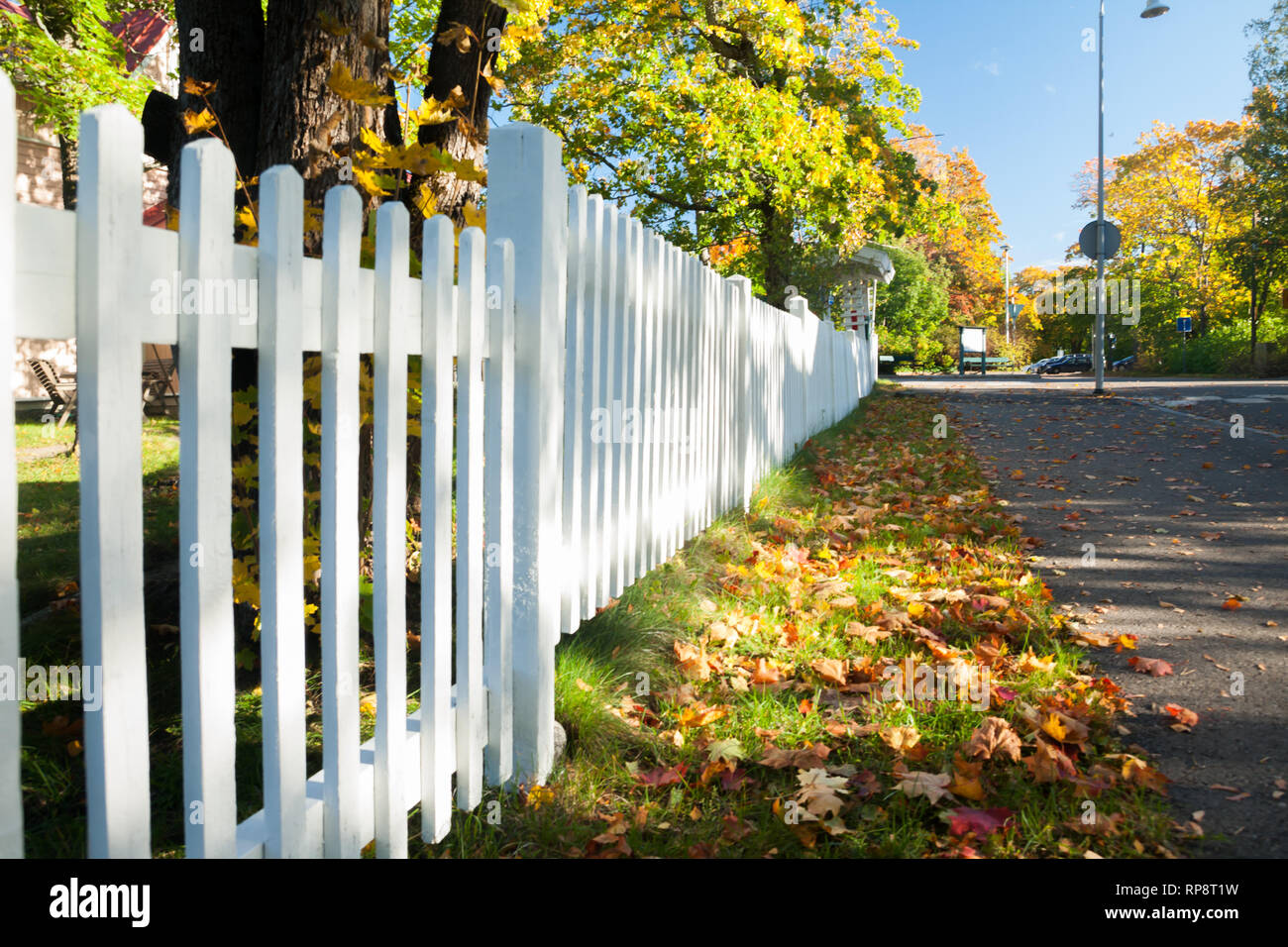 Beautiful colorful autumn scene with white fence and fall colors in ...