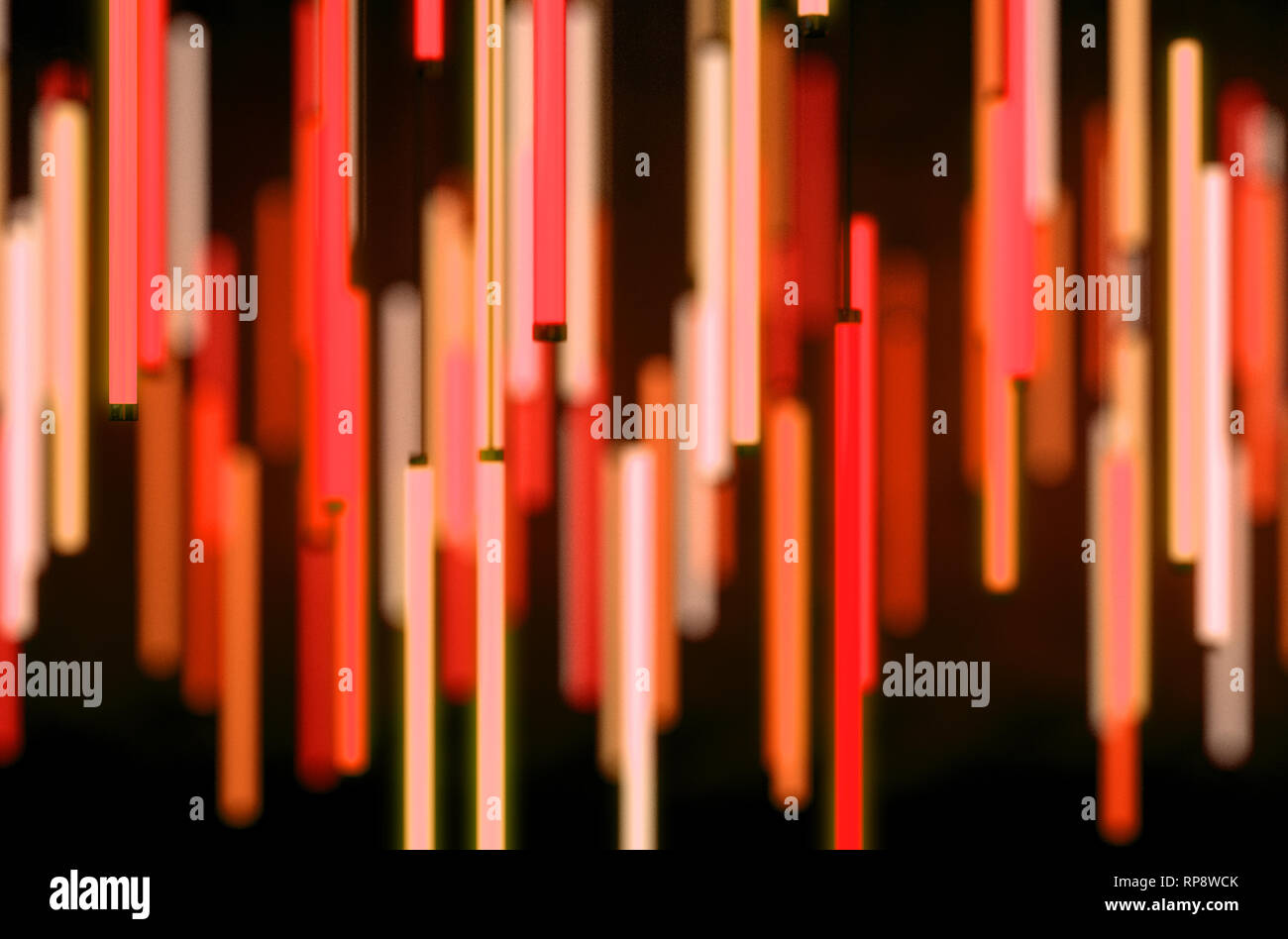 A collection of red florescent tube lights hanging from scaffolding on ...