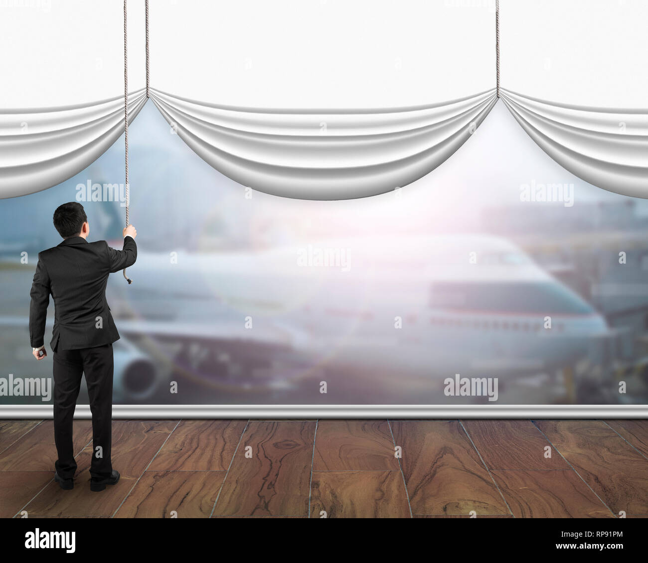 A businessman pulling open white blank curtain showing airplane ...