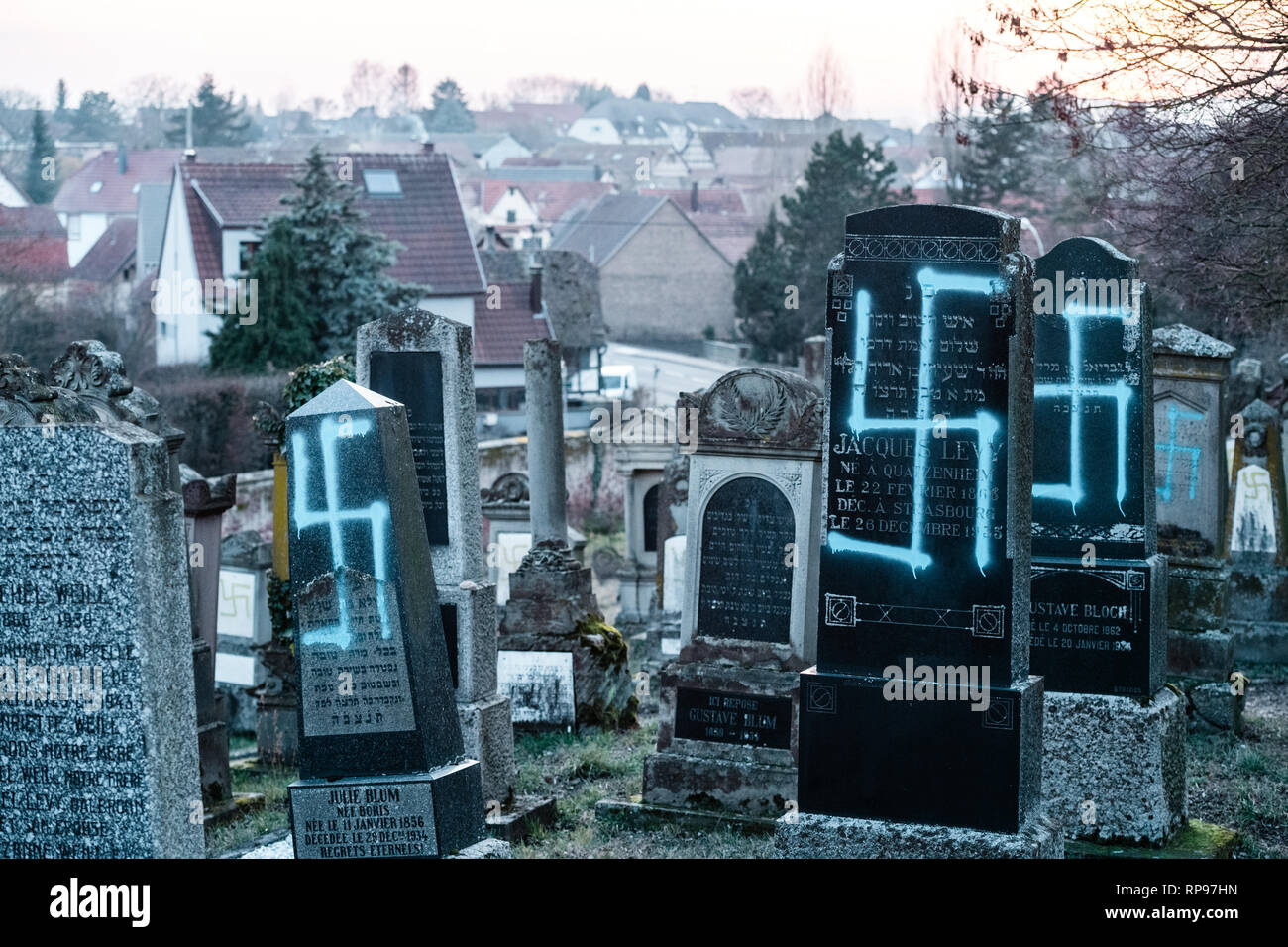 Blue cold color tones of vandalised graves with nazi symbols in blue ...