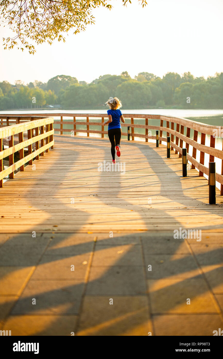 Woman practicing running on bridge hi-res stock photography and images ...
