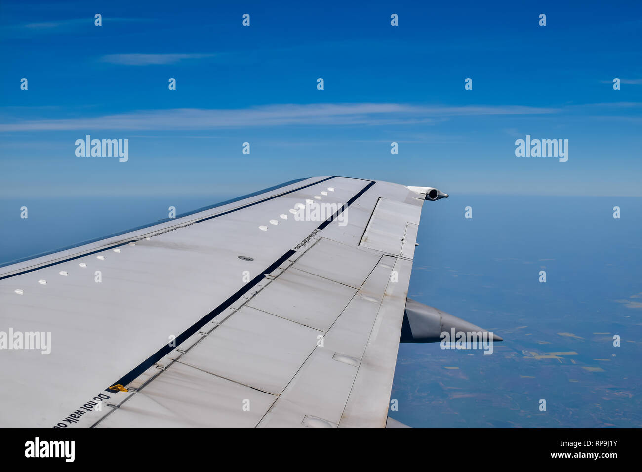 The right wing of a plane through the clear sky Stock Photo - Alamy