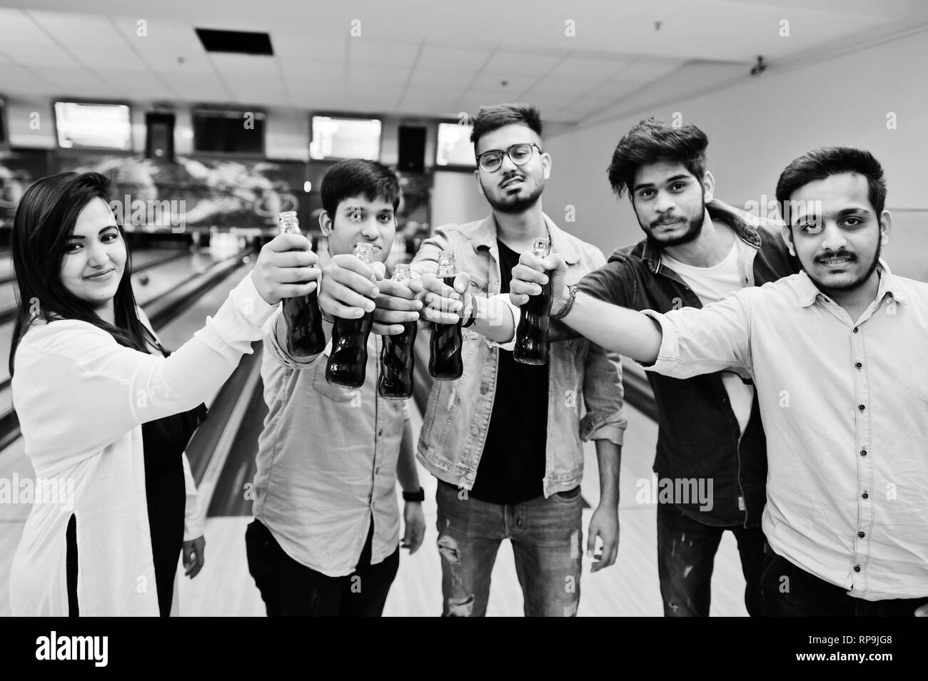 Group of five south asian peoples having rest and fun at bowling club ...