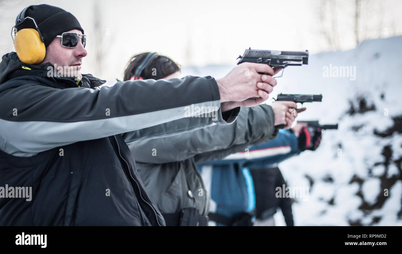 Group of civilian practice gun shoot on target on outdoor shooting ...