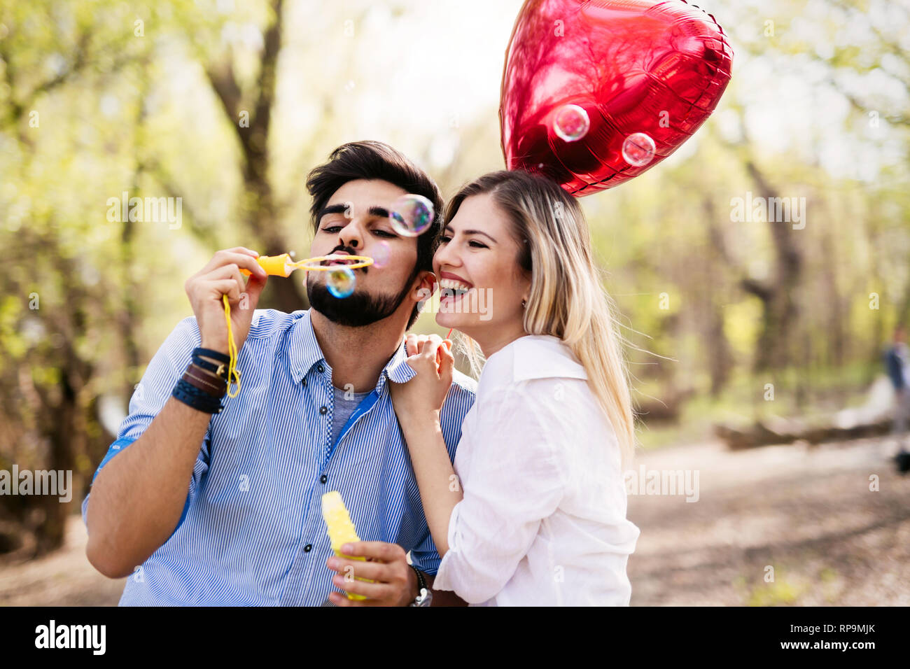 Picture of romantic couple standing outside with baloons Stock Photo ...
