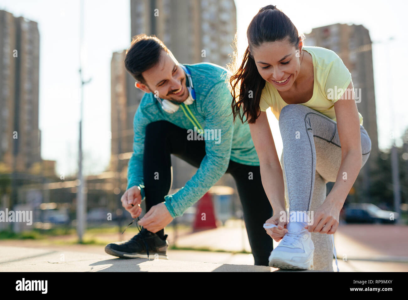Runners tying running shoes and getting ready to run Stock Photo - Alamy