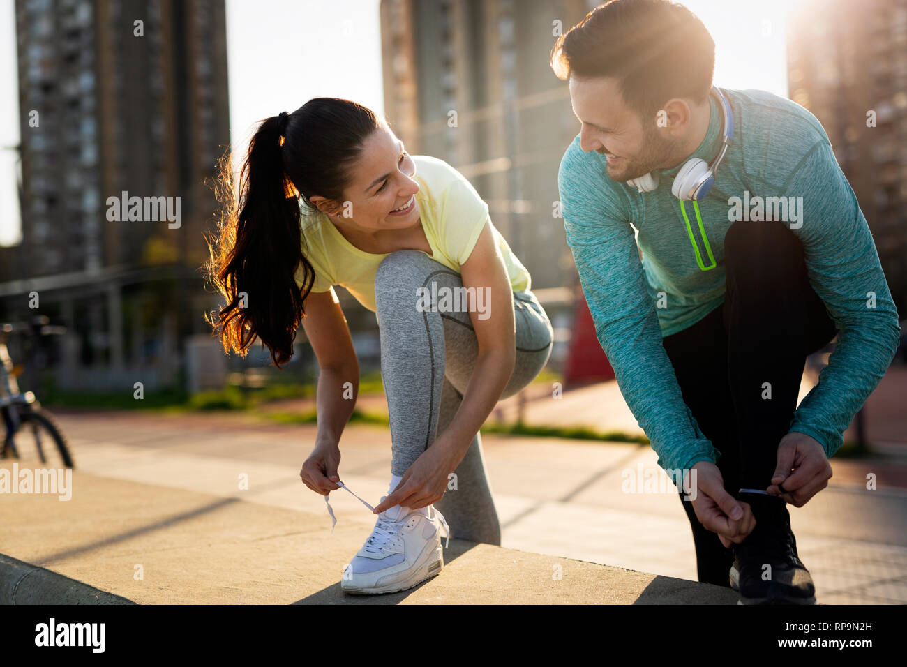 Male female runners tying hi-res stock photography and images - Alamy
