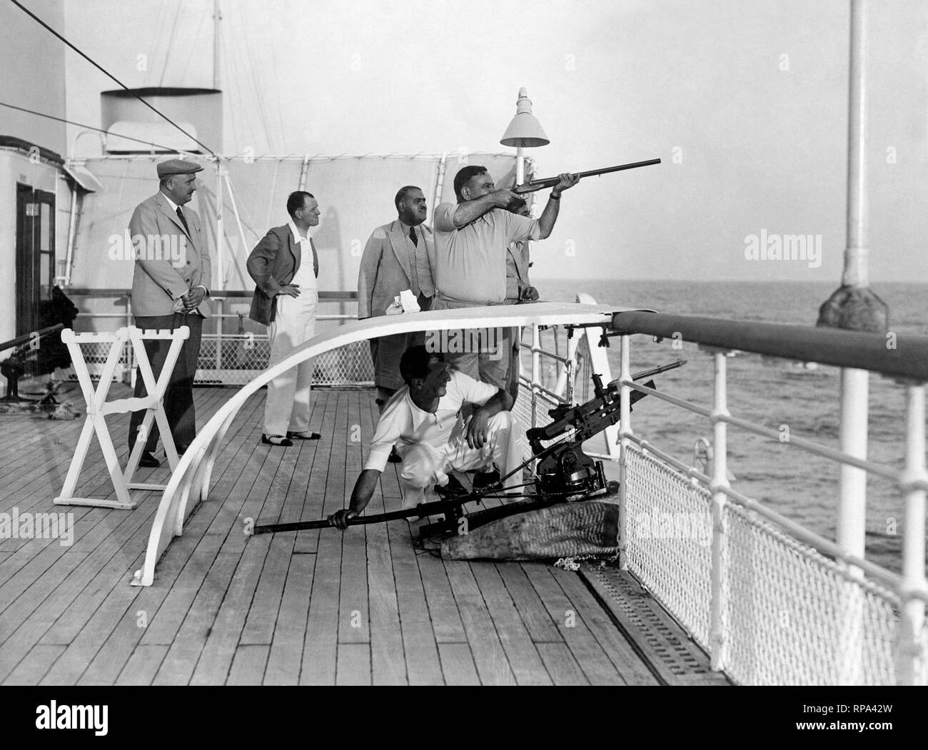 Men shooting outdoors Black and White Stock Photos & Images - Alamy