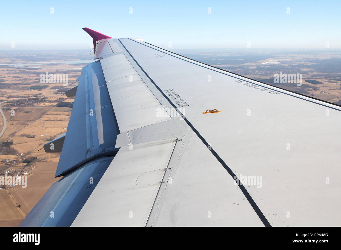 Flying over Sweden in winter. Wing view of a modern passenger aircraft ...