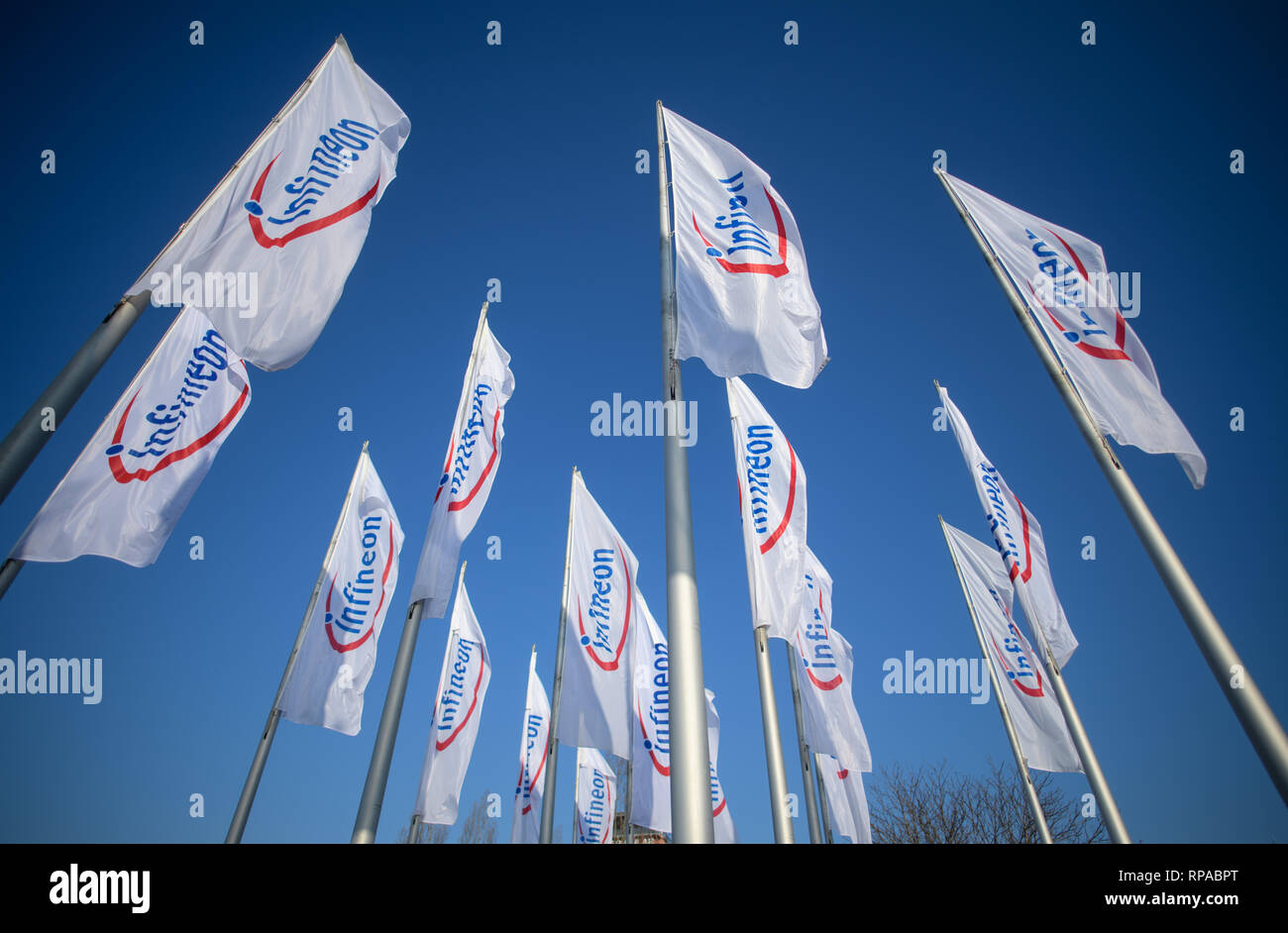 21 February 2019, Bavaria, München: Flags with the Infineon logo waft ...