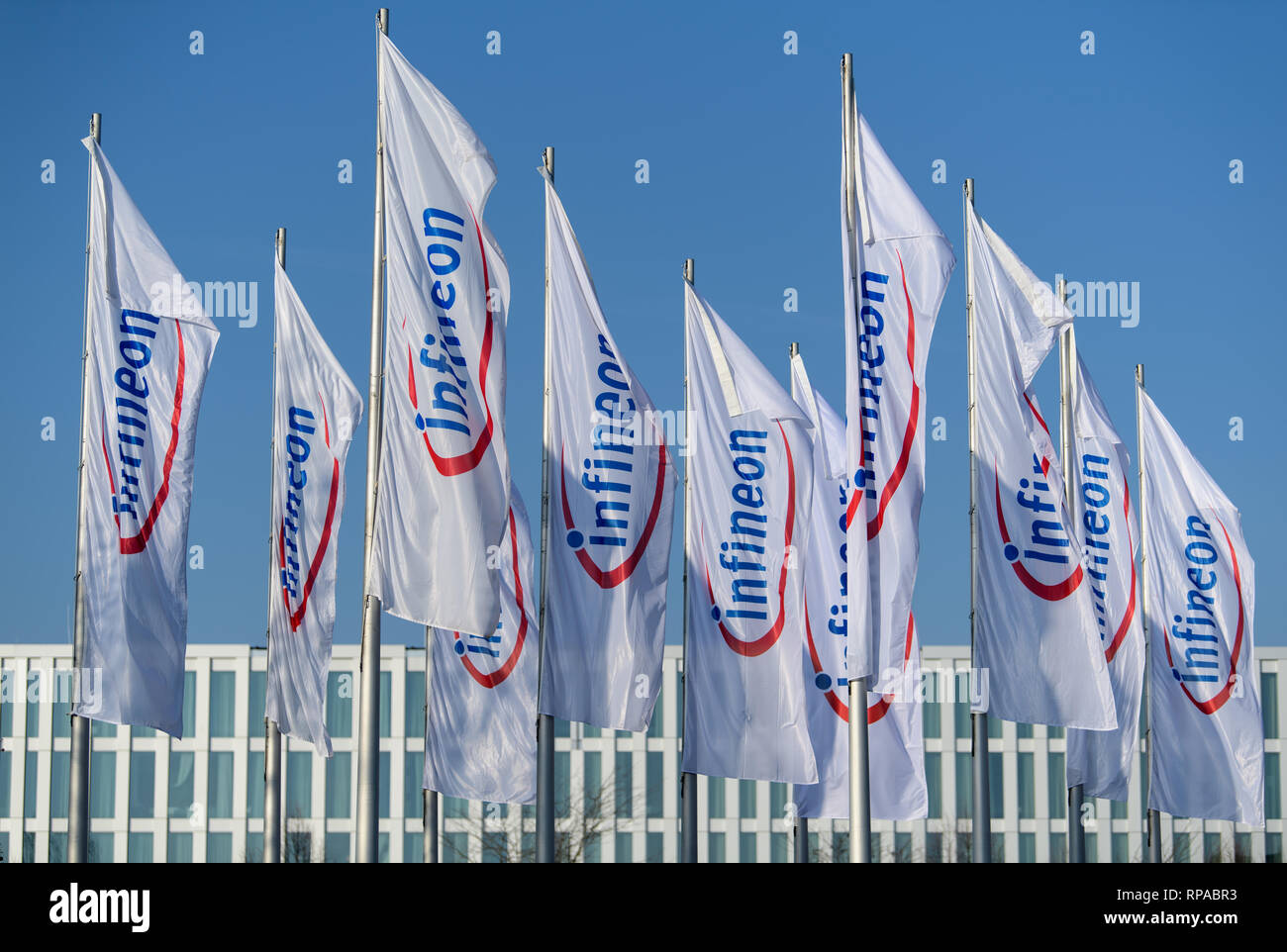 21 February 2019, Bavaria, München: Flags with the Infineon logo waft ...