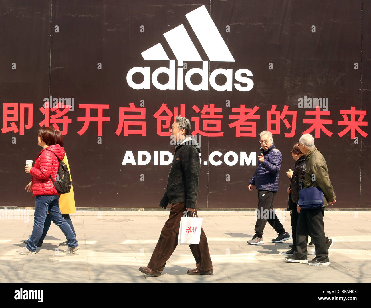 FILE--A Pedestrian Walks Past An Advertisement For Adidas, 58% OFF