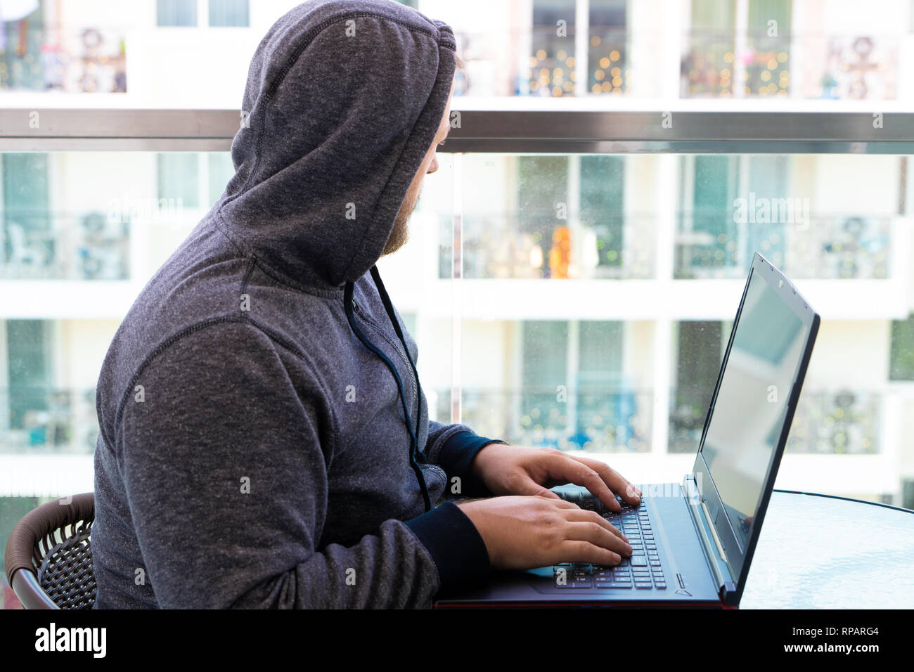 Cybercrime, hacking and technology concept - male hacker writing code ...