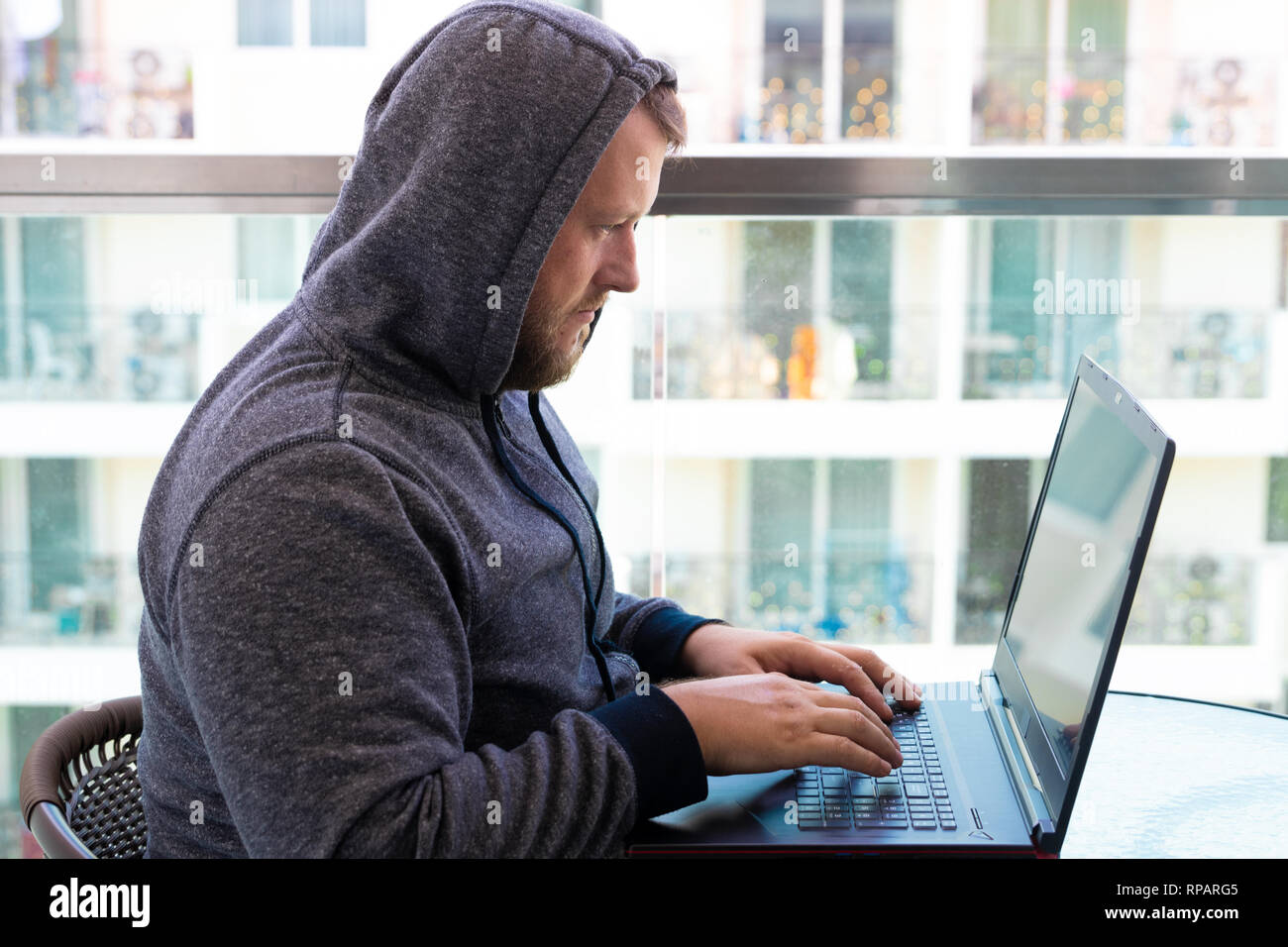 Cybercrime, hacking and technology concept - male hacker writing code ...