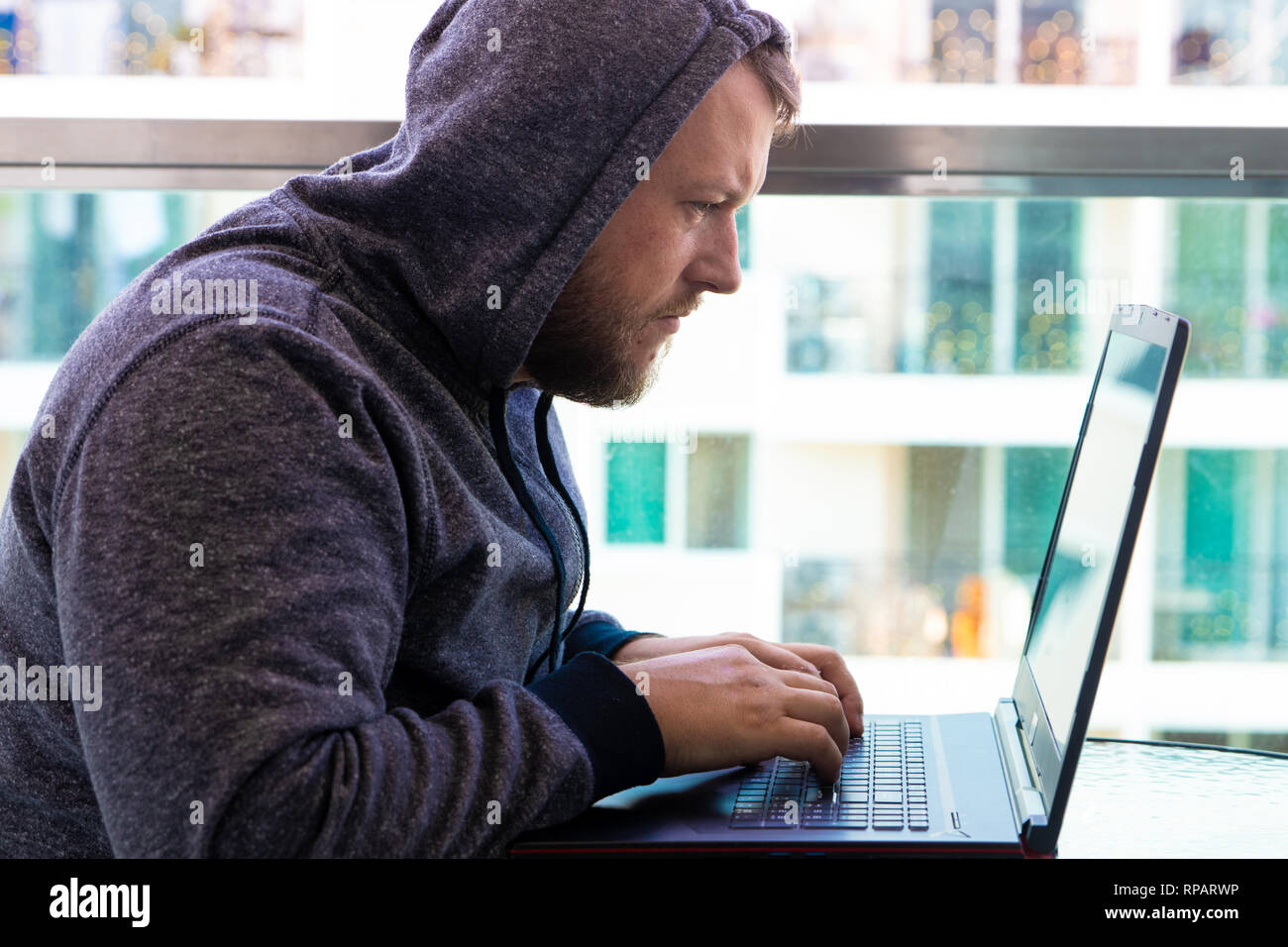 Cybercrime, hacking and technology concept - male hacker writing code ...