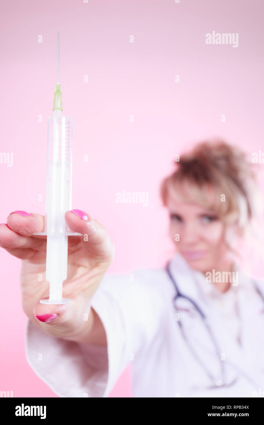 Injection concept. Female doctor with close up big syringe and ...