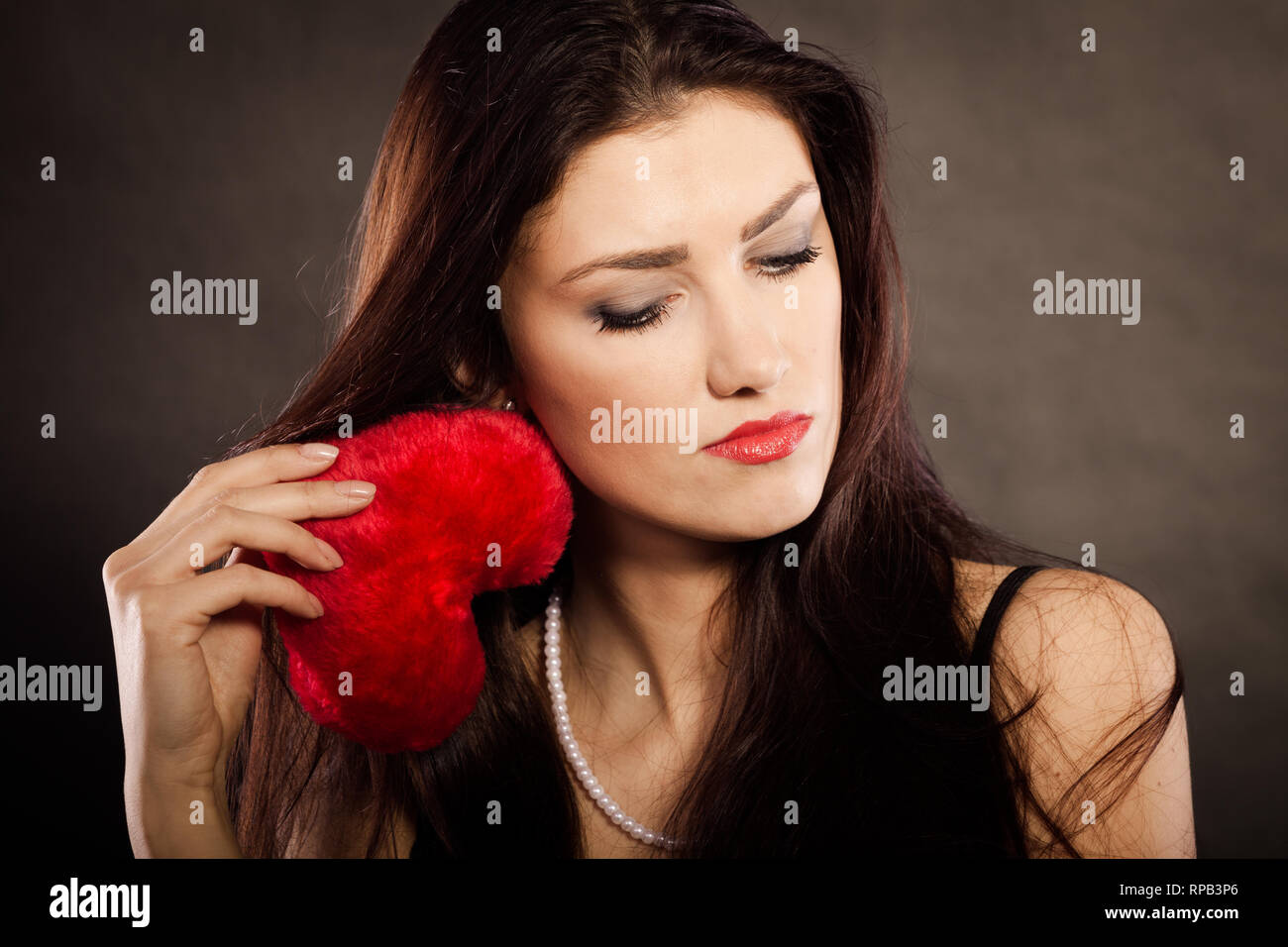 Woman brunette long hair girl wearing black dress holding red heart ...