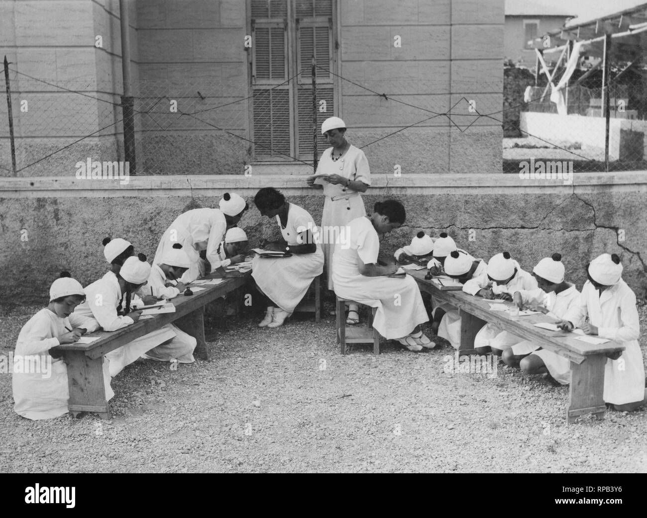 italy, summer camp, children writing letters, 20s Stock Photo - Alamy