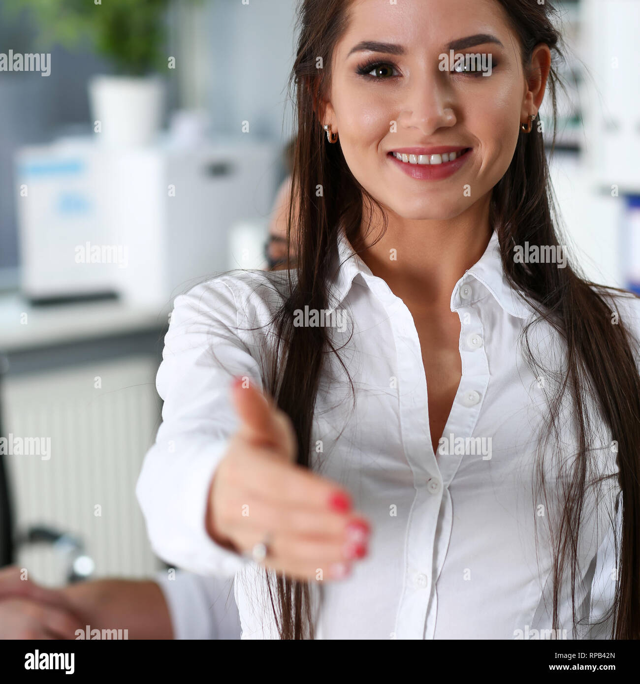 Woman in suit give hand as hello in office Stock Photo - Alamy