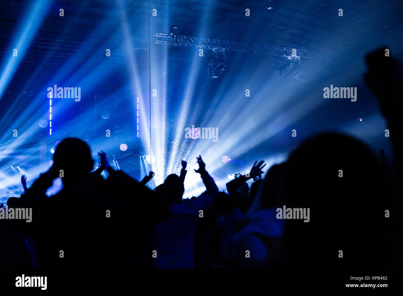 Concert crowd having fun at a rock concert. Large concert hall with a ...