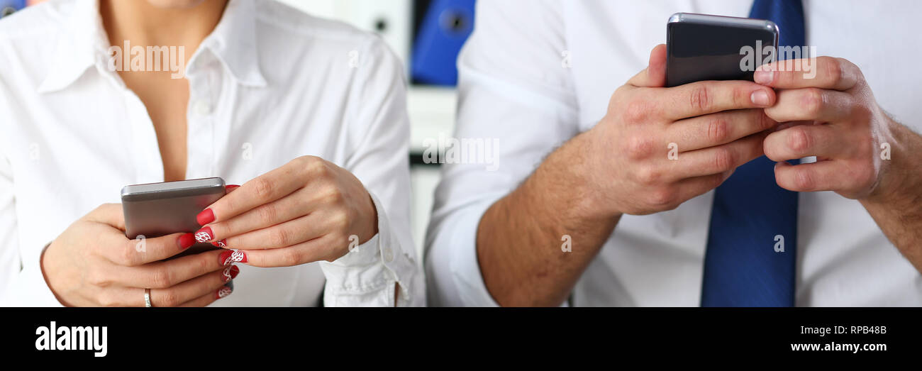 Group of people look at phones in arms Stock Photo - Alamy
